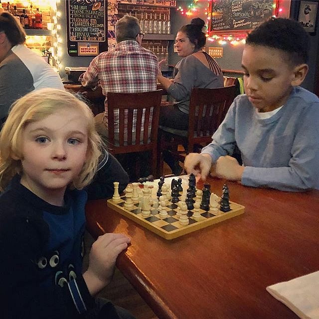 Erudites Errol and Kai play chess while their mama’s watch college ...